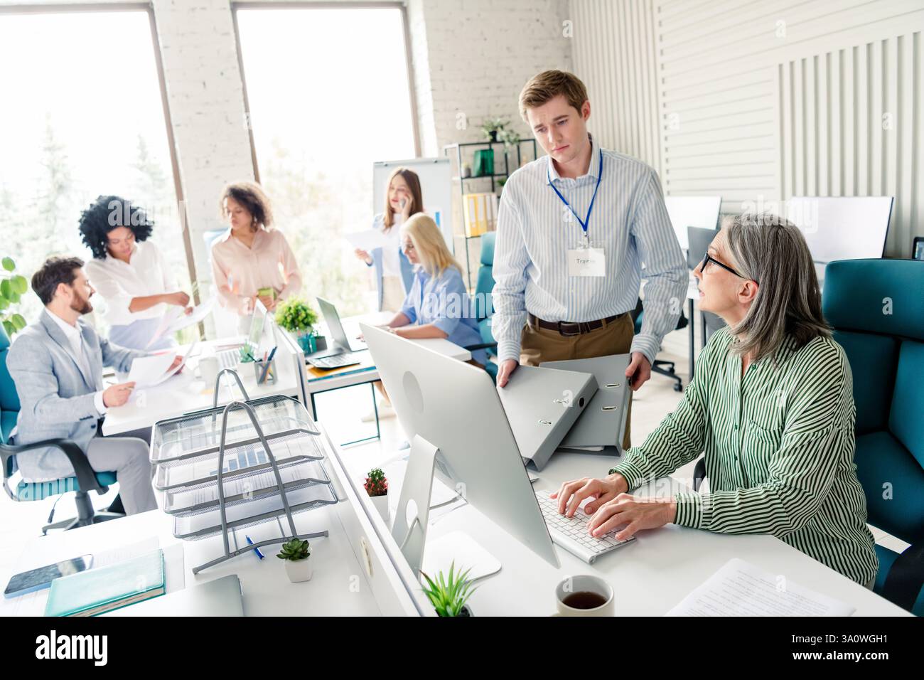 Busy working office with professionals collaborating on tasks during ...
