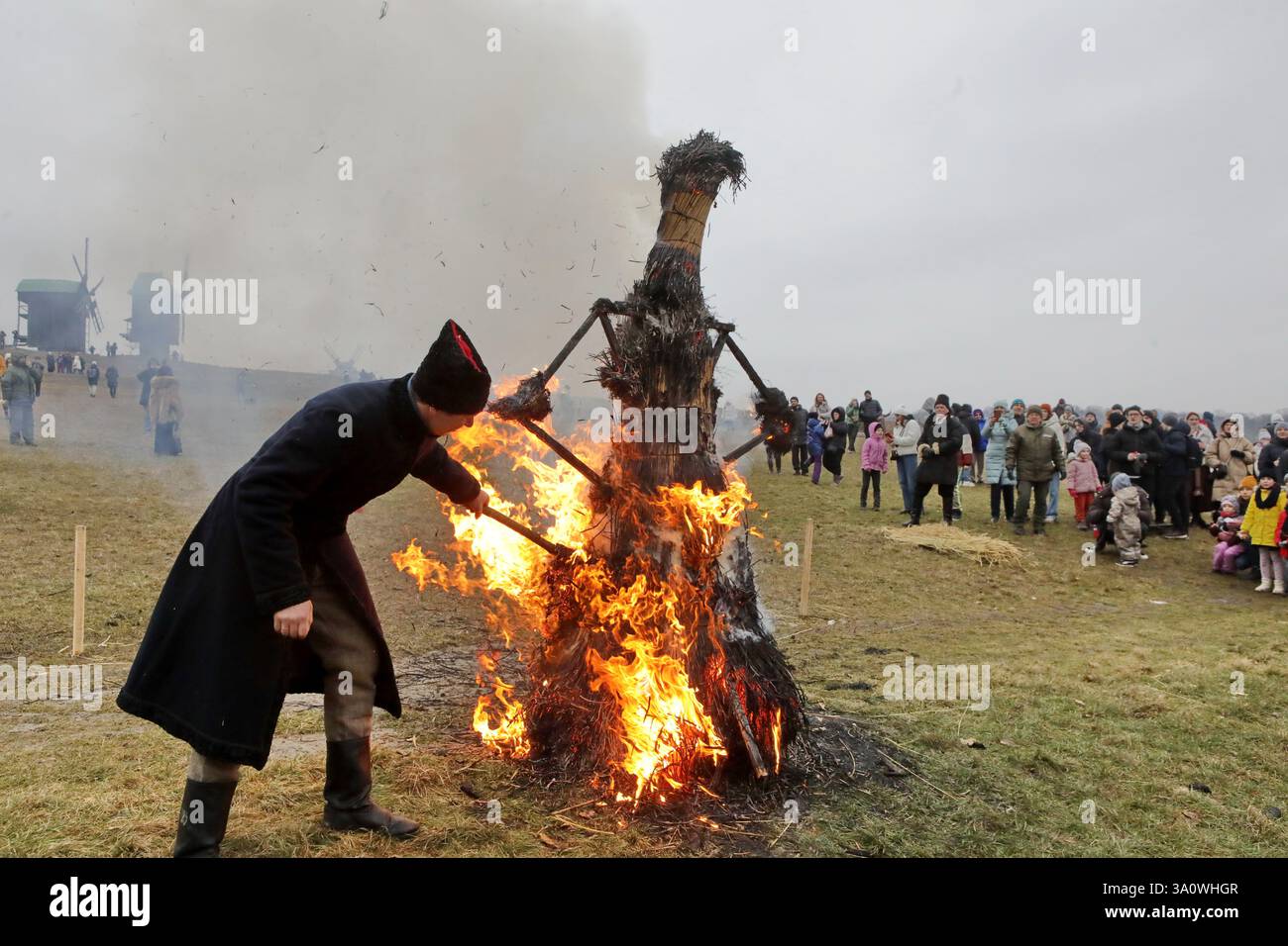 A man sets an effigy on fire to mark the end of the Kolodii. Masnytsia ...