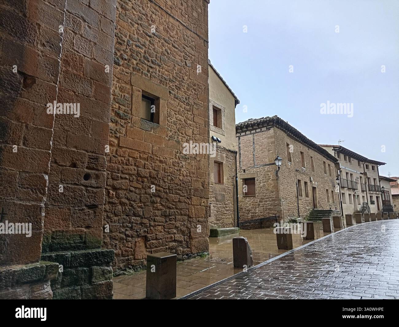 Wet cobblestone street in the medieval town of Laguardia, Alava, Spain ...