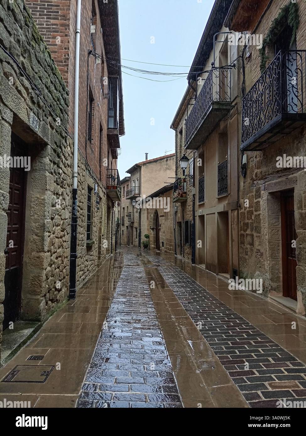 Wet cobblestone street in the medieval town of Laguardia, Alava, Spain ...