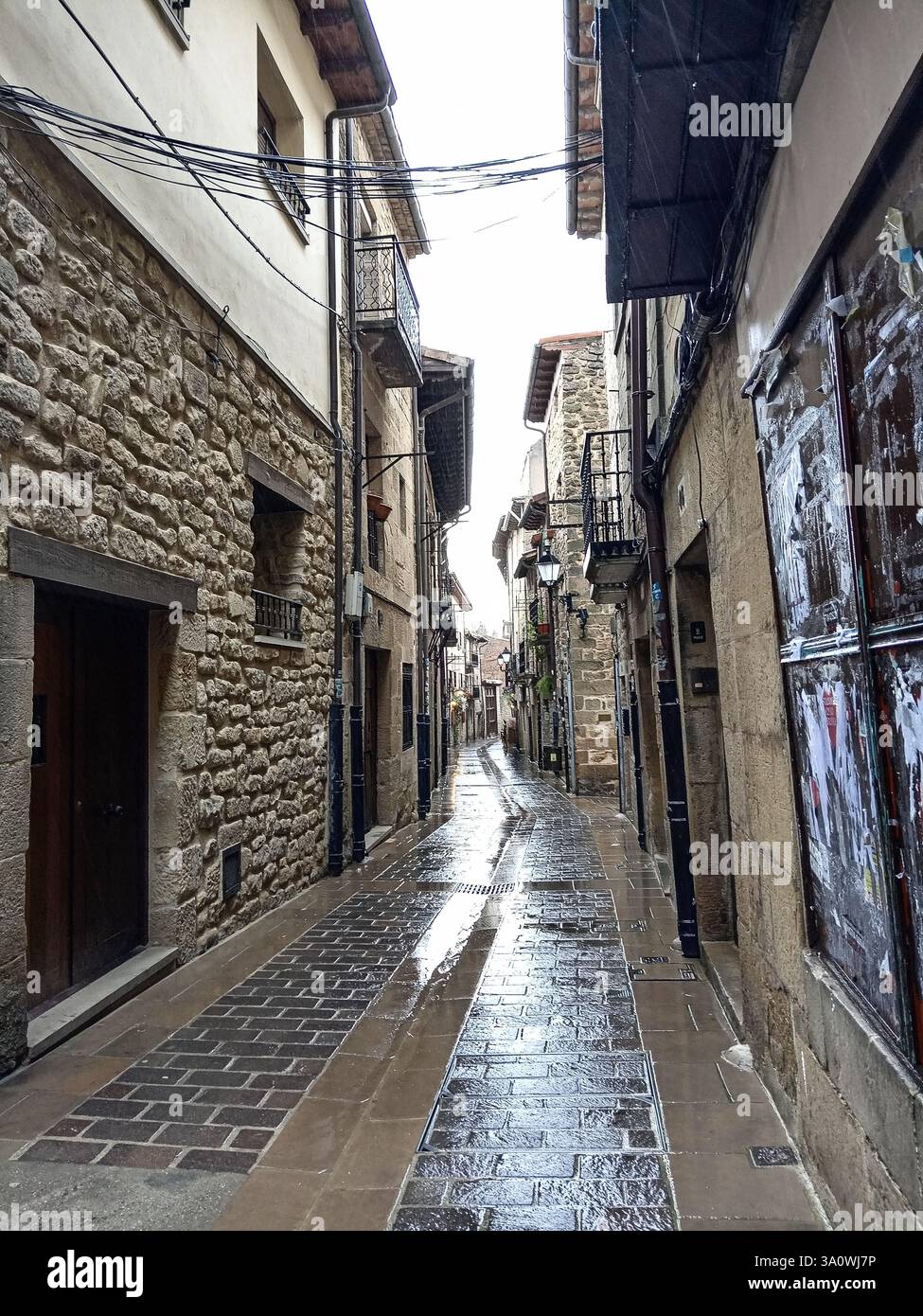 Wet cobblestone street in the medieval town of Laguardia, Alava, Spain ...