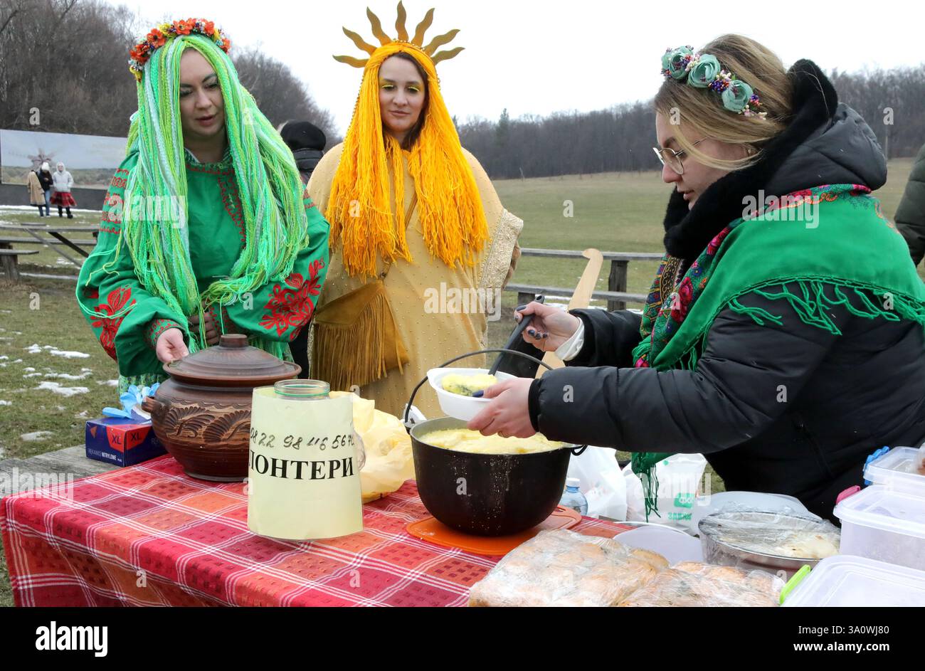 A woman serves food during the Kolodii. Masnytsia festival at the ...