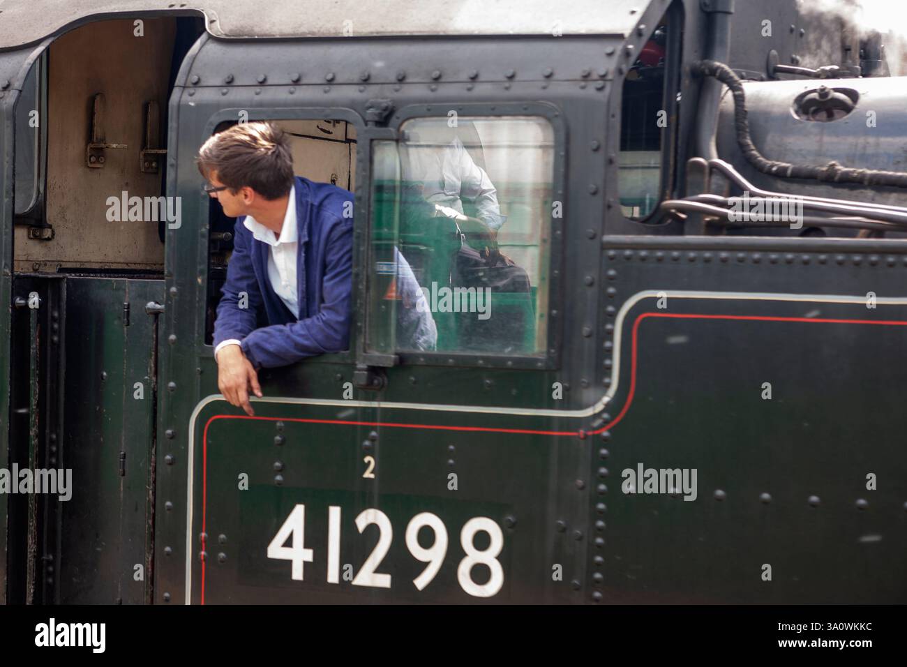 Fireman on the footplate of steam locomotive Ivatt Class 2 41298 at ...