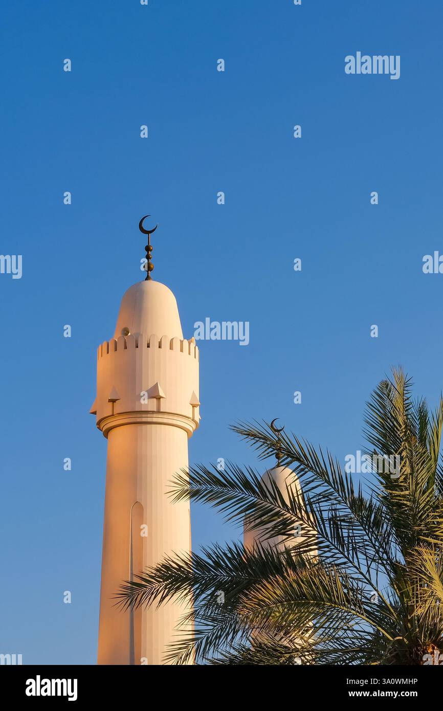 Minaret of Muslim islamic mosque or masjid on blue sky background an ...