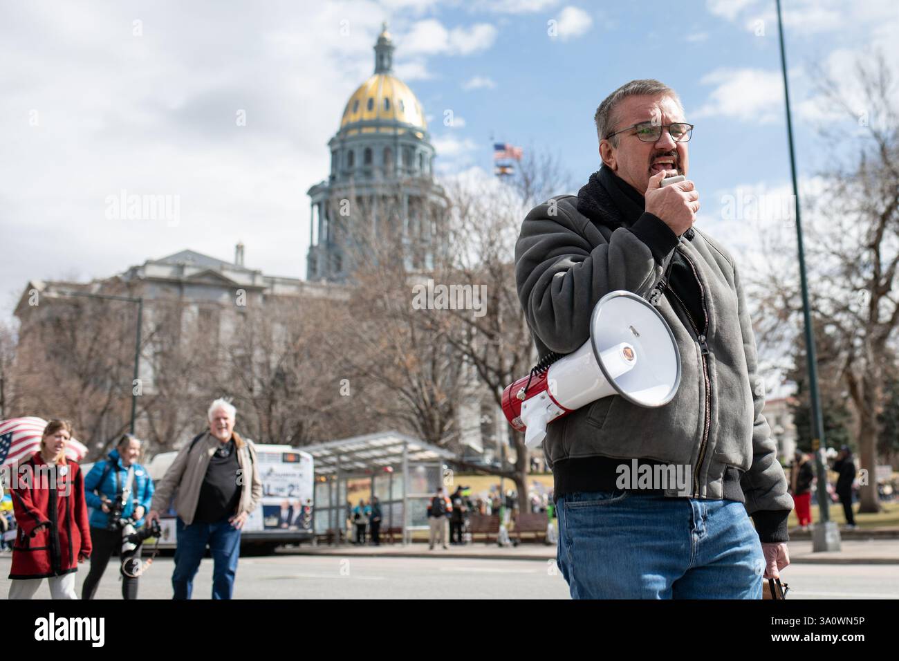 Denver, Colorado, USA. 4th Mar, 2025. A man shouts into a megaphone at ...