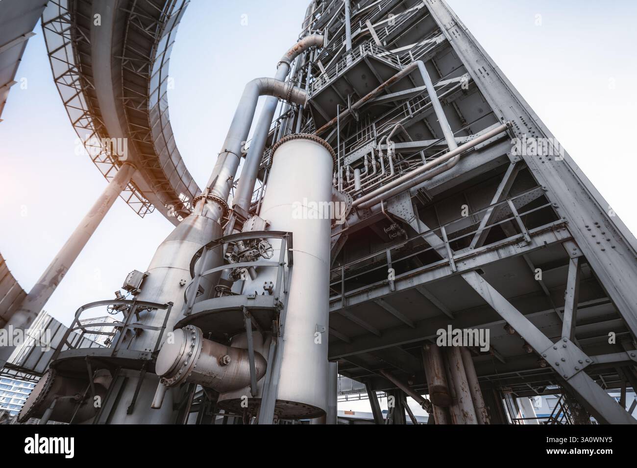 Low-angle view of an industrial metal structure with interconnected ...