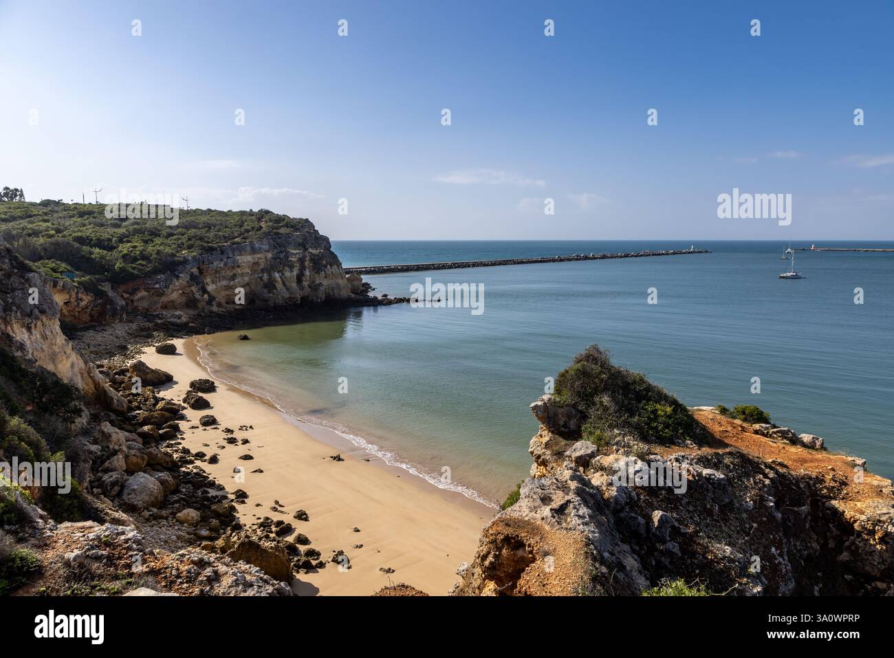 A view over Praia da Infanta on the Algarve coast, with a blue sky ...