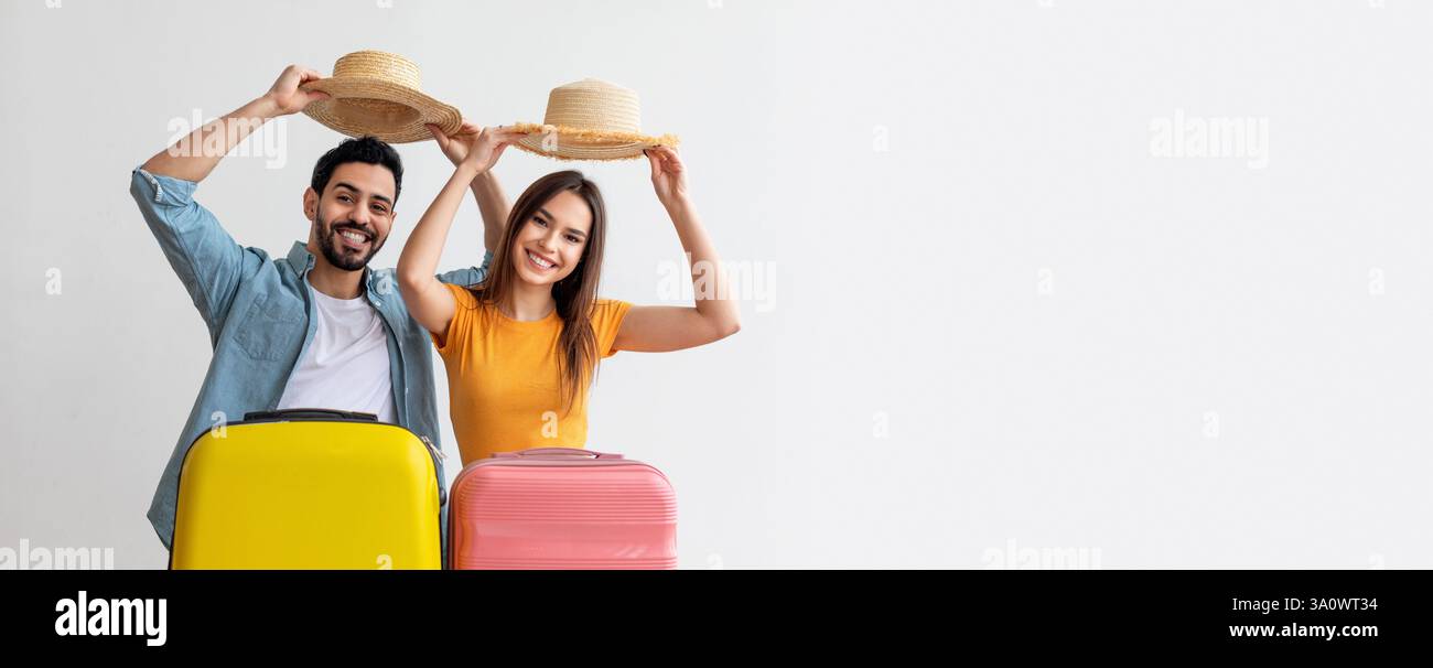 Family vacation. Happy tourist couple taking off hats with greeting ...