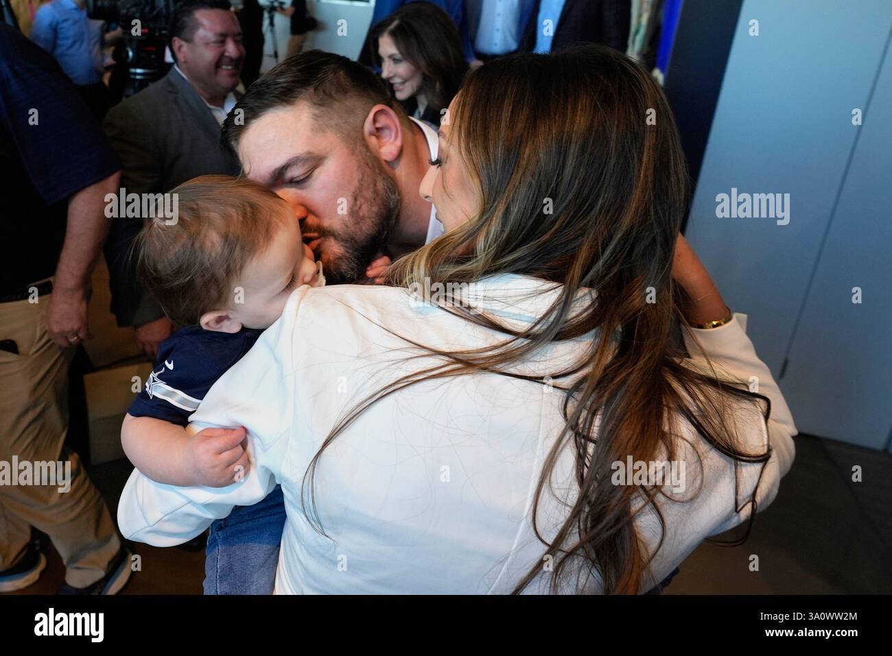 Dallas Cowboys lineman Zach Martin, center, kisses his son Hudson Gage ...