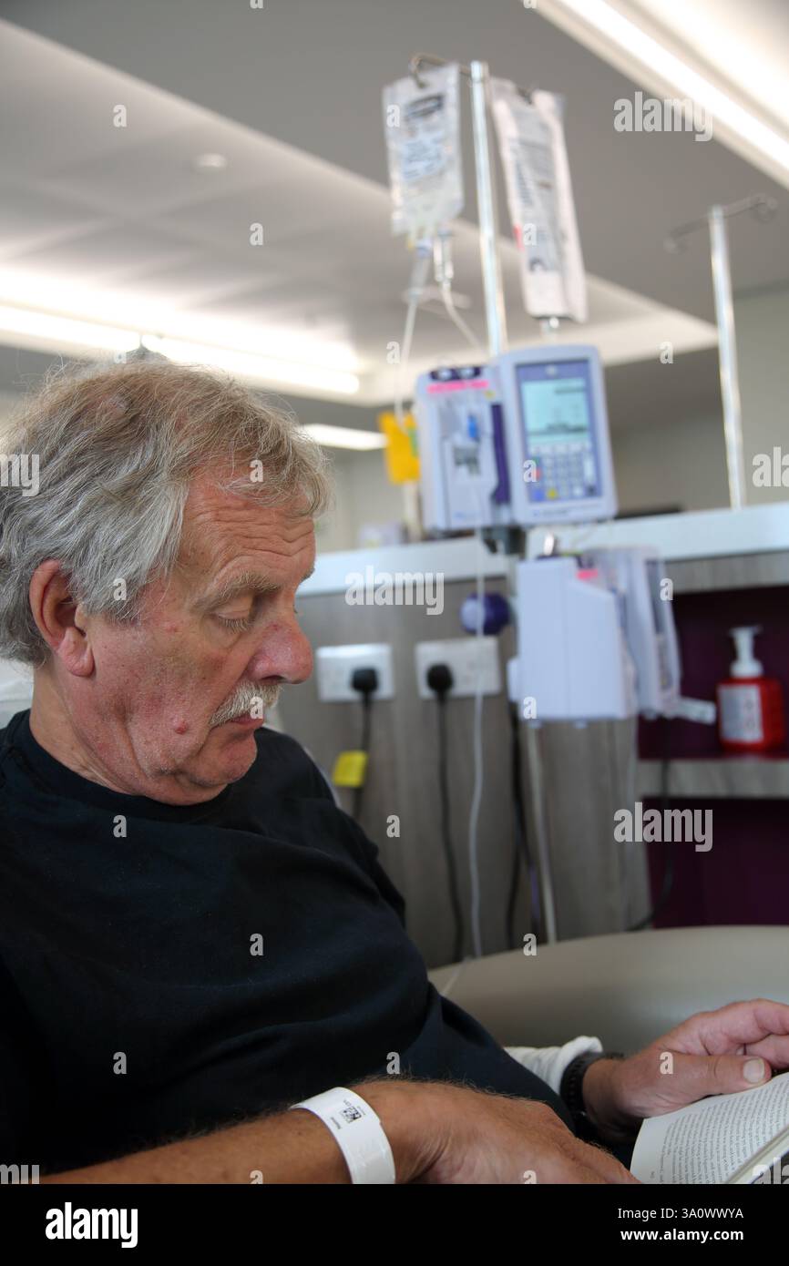 Cancer Patient Reading Book whilst having Chemotherapy Treatment with ...