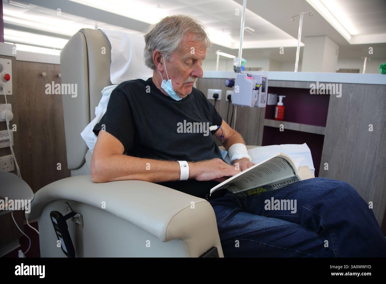 Cancer Patient Reading Book whilst having Chemotherapy Treatment with ...