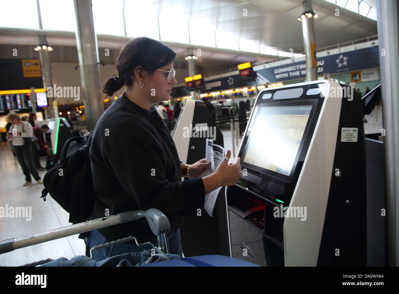 Woman Using Self Check-in at London Heathrow Airport England Stock ...