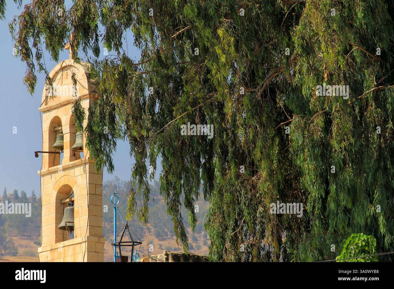 A serene image depicting a traditional bell tower adjoining a church ...
