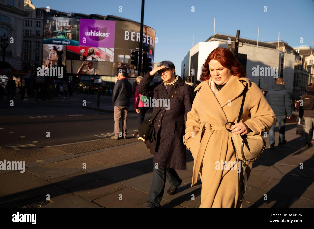 Pedestrians along Piccadilly, in the heart of the Mayfair district in London, enjoying the ...