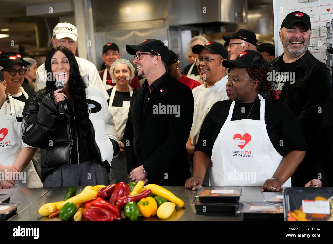 Cher, left, visits the God's Love We Deliver kitchen on Wednesday ...