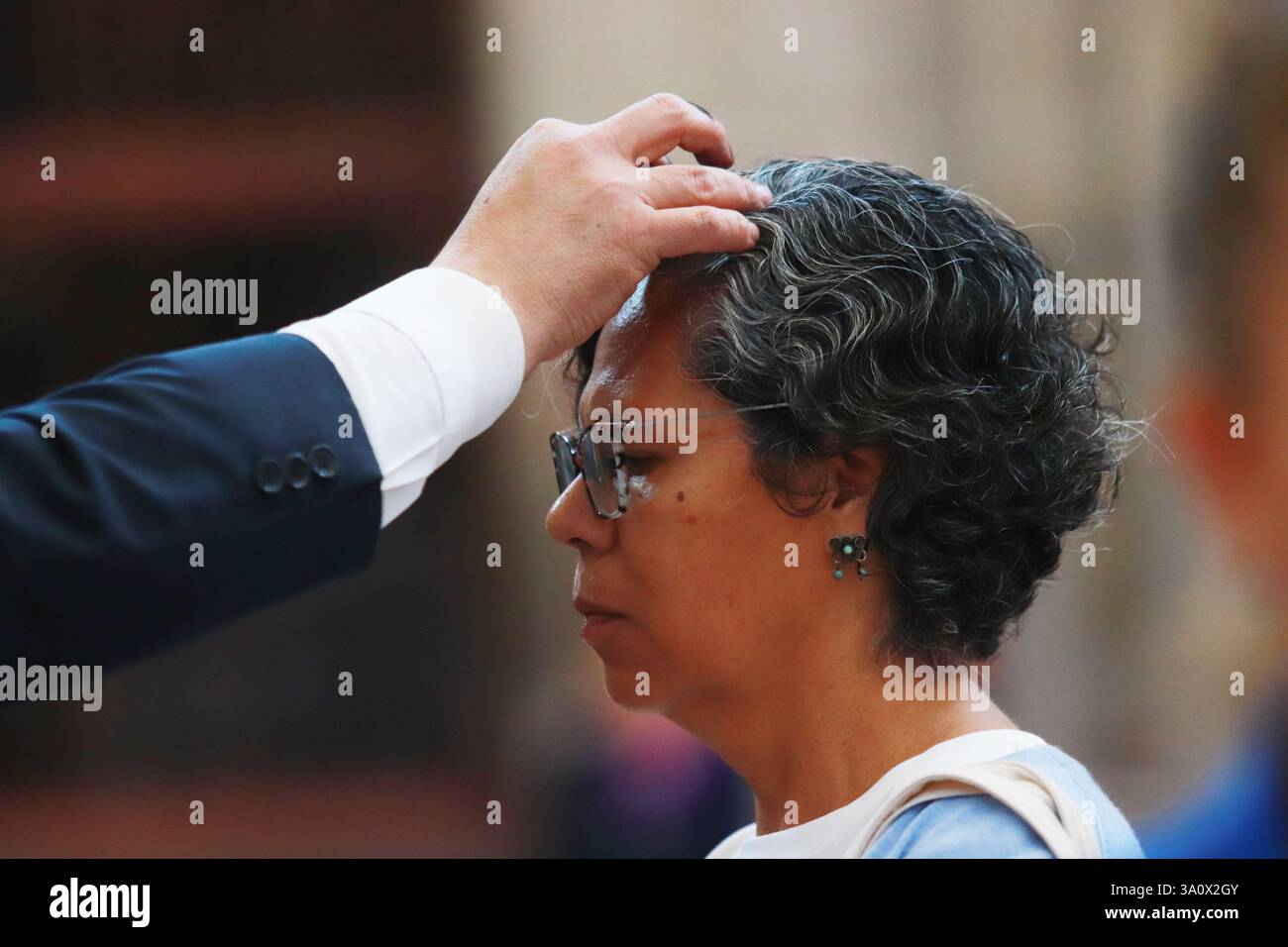 A Faithful catholic receives ashes during the imposition of ashes at ...