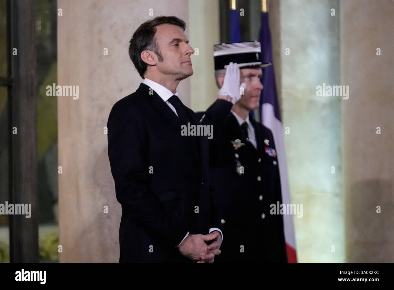 French President Emmanuel Macron stands outside the Elysee Palace ...