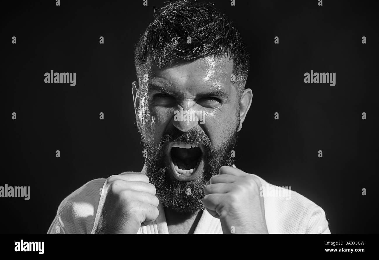 Karate man. Closeup portrait of karate instructor in kimono. Screaming ...