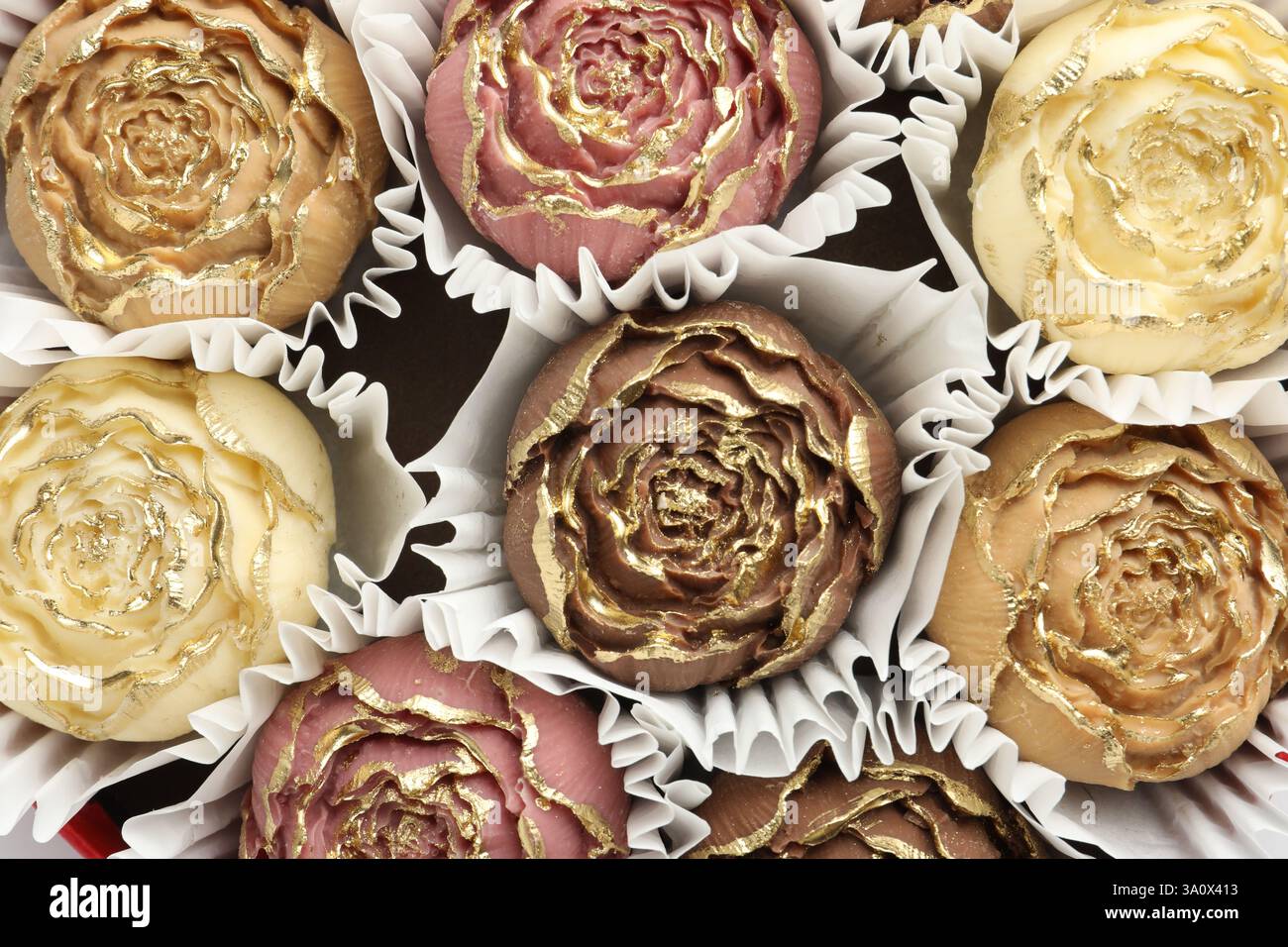 Flower shaped chocolate bonbons as background, top view Stock Photo - Alamy