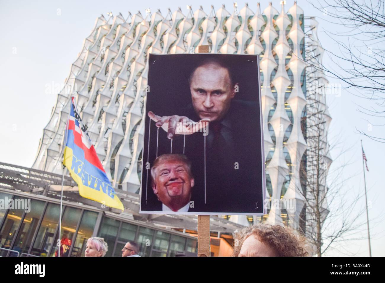 London, UK. 5th March 2025. A protester holds a sign depicting Trump as ...