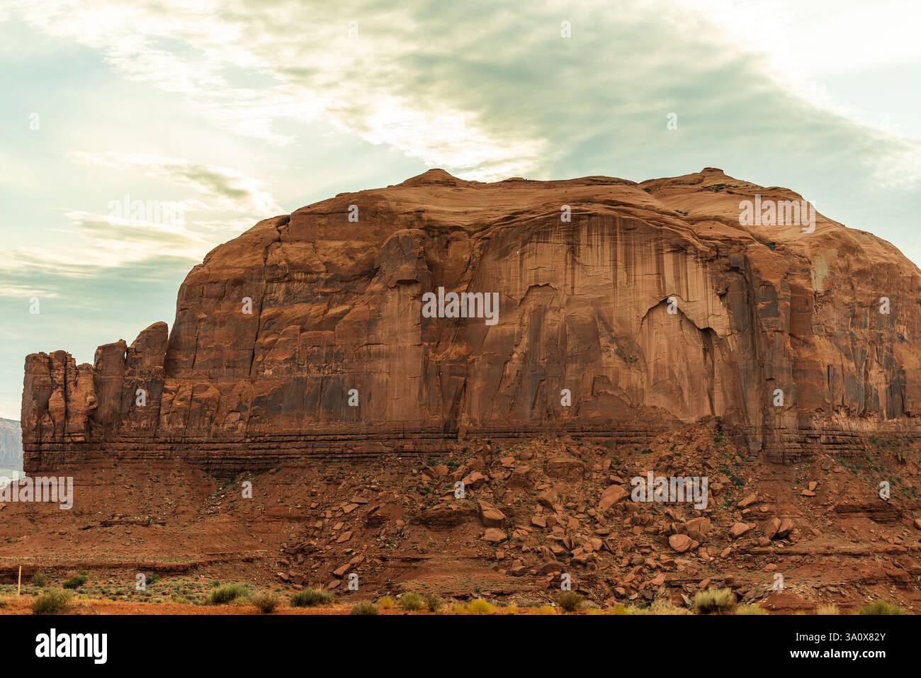 Massive sandstone rock formation in Monument Valley under cloudy sky ...