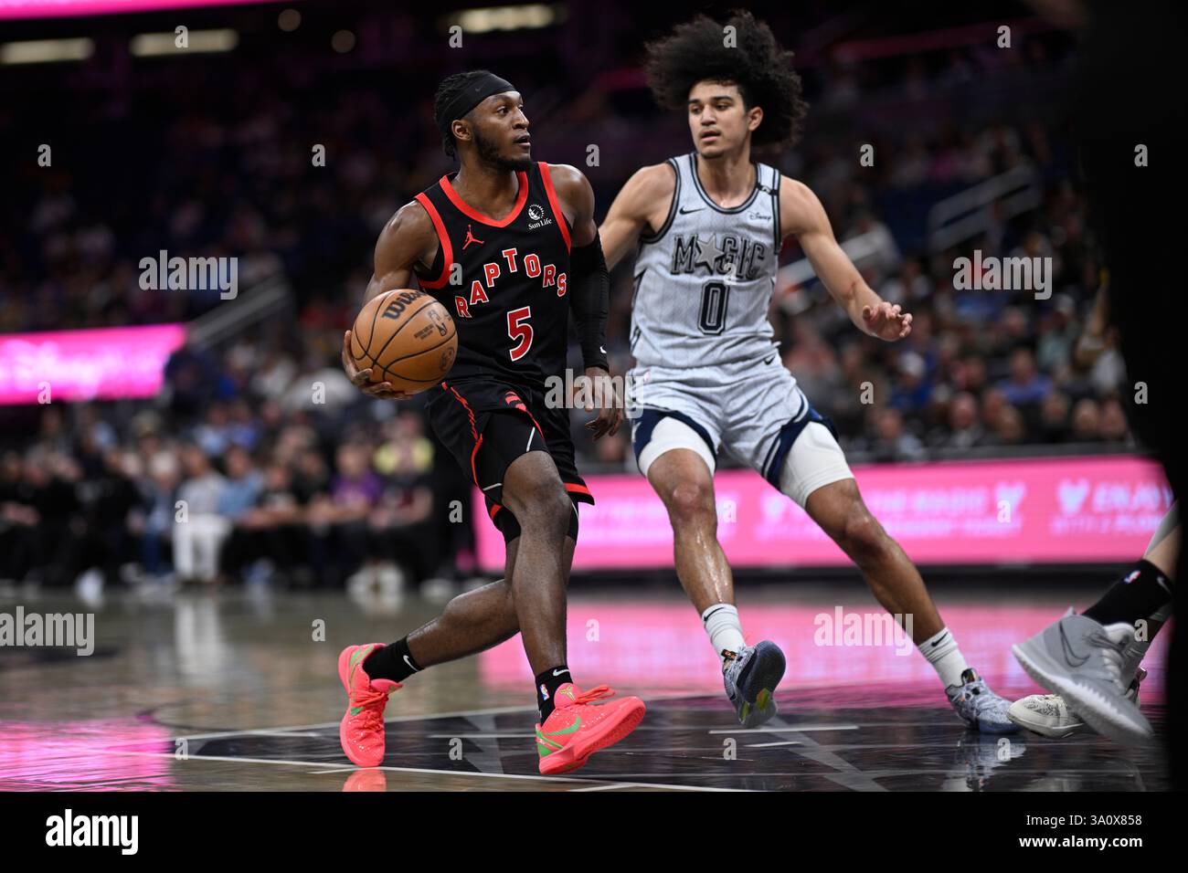 Toronto Raptors guard Immanuel Quickley (5) is defended by Orlando ...