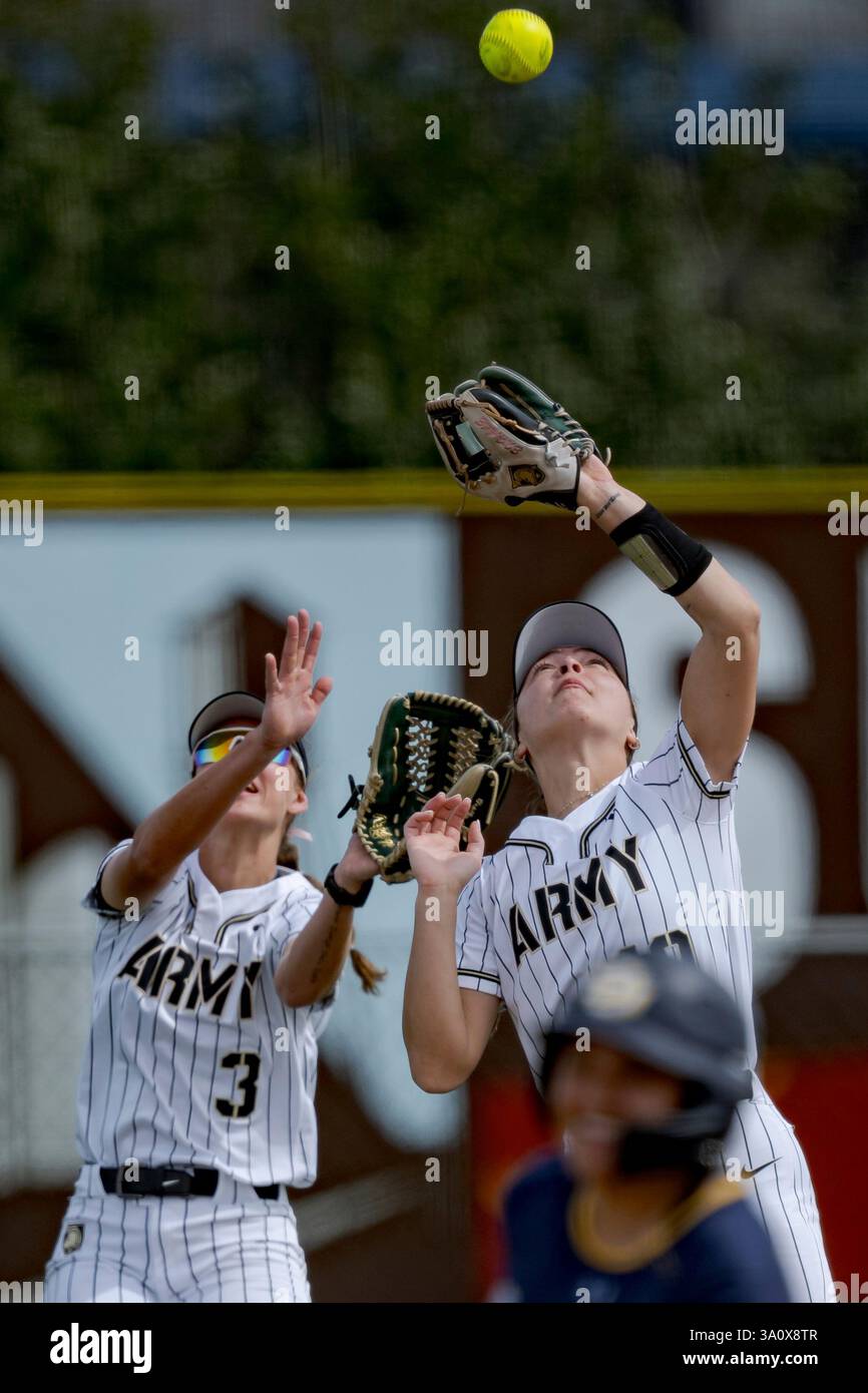 Army infielder Sam Bocis (10), right, catches a ball for an out next to ...