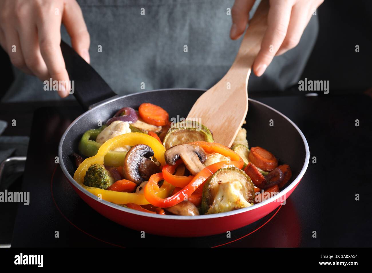Woman frying vegetables mushrooms hi-res stock photography and images ...