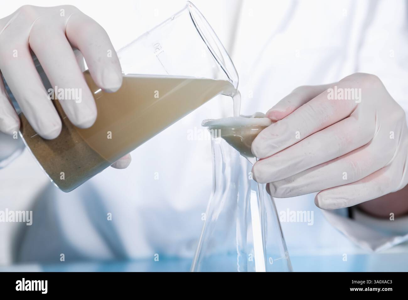 Laboratory testing. Scientist filtering soil sample, closeup Stock ...