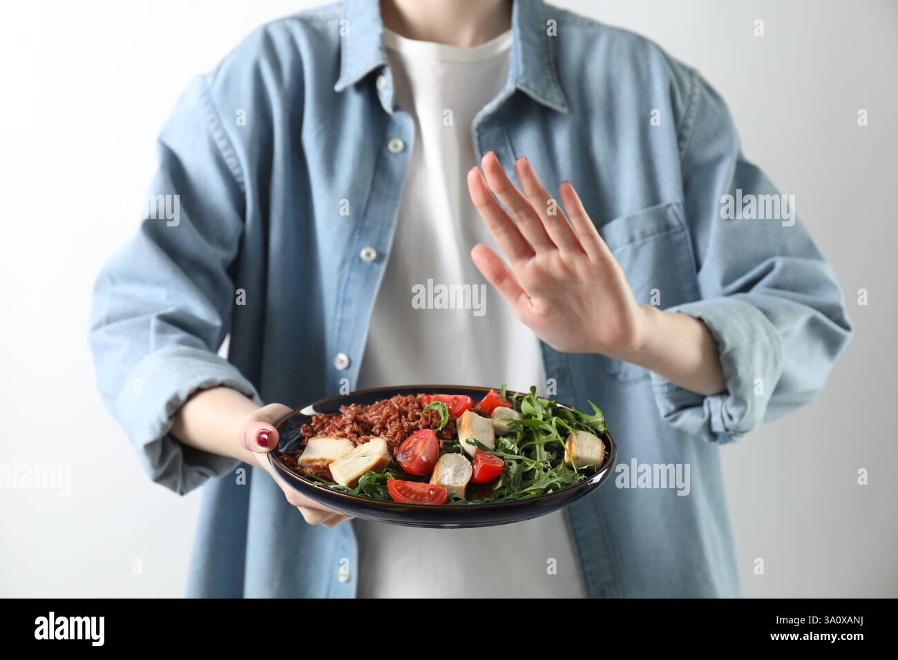 Woman refusing to eat meal on white background, closeup. Food allergy ...
