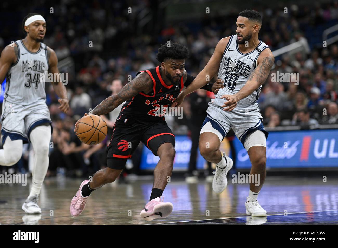 Toronto Raptors guard Jamal Shead (23) drives between Orlando Magic ...