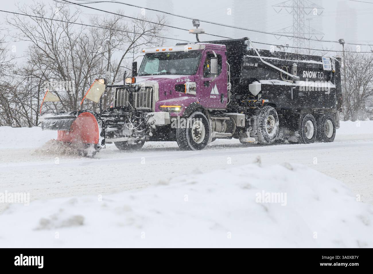 Toronto, ON, Canada - February 27, 2025: A snow plow clears the road ...