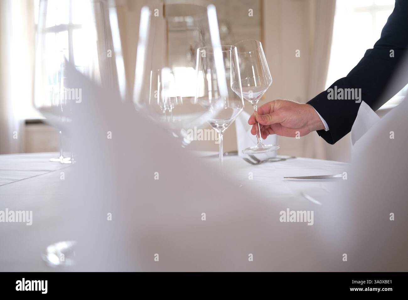 Stuttgart, Germany. 27th Feb, 2025. A waiter sets a table in a ...