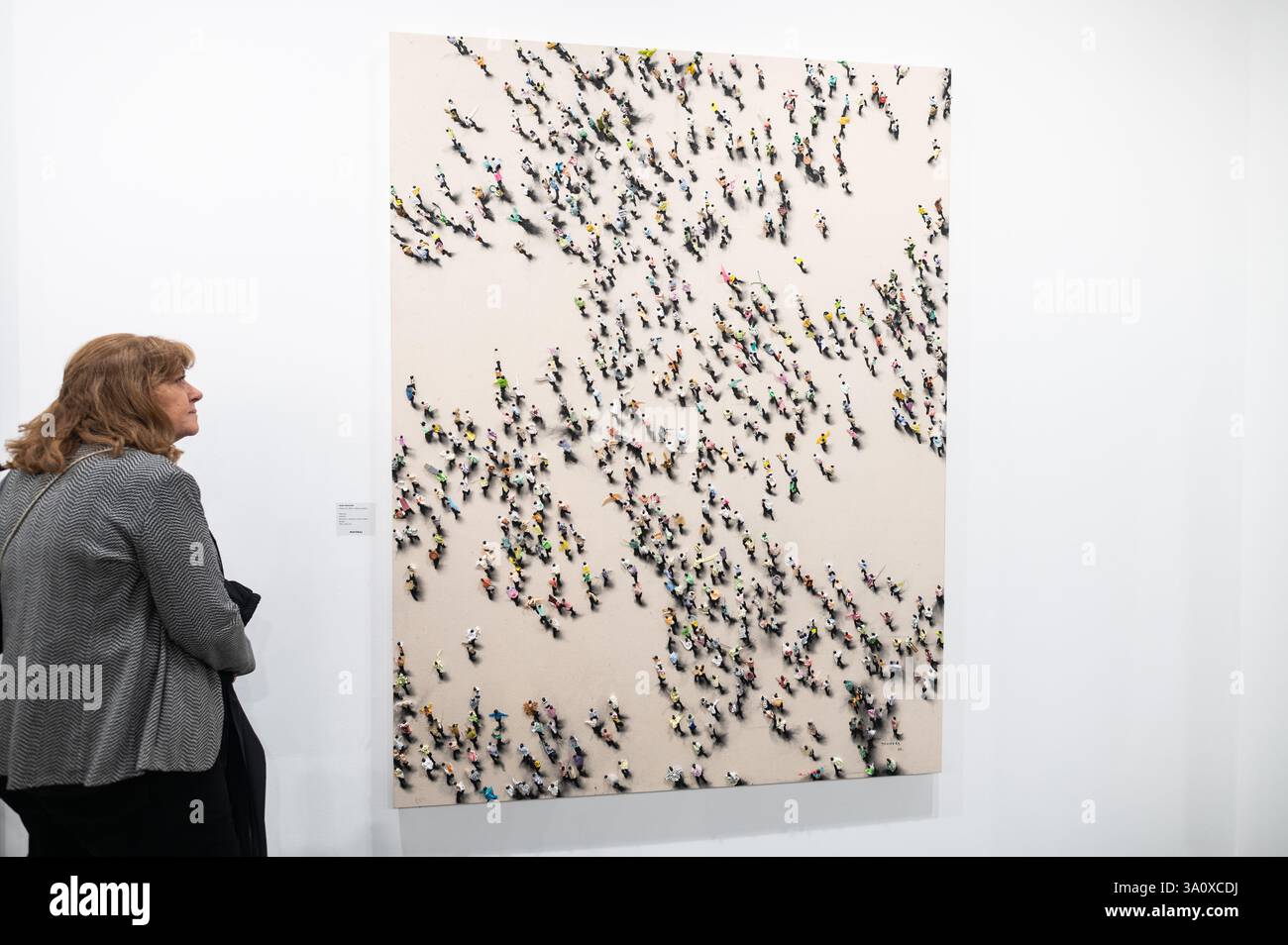 A visitor observes an artwork of artist Juan Genoves during the ...