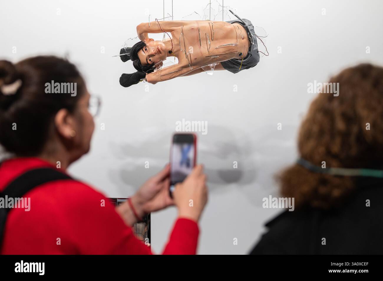 Madrid, Spain. 05th Mar, 2025. A visitor takes pictures of an artwork ...