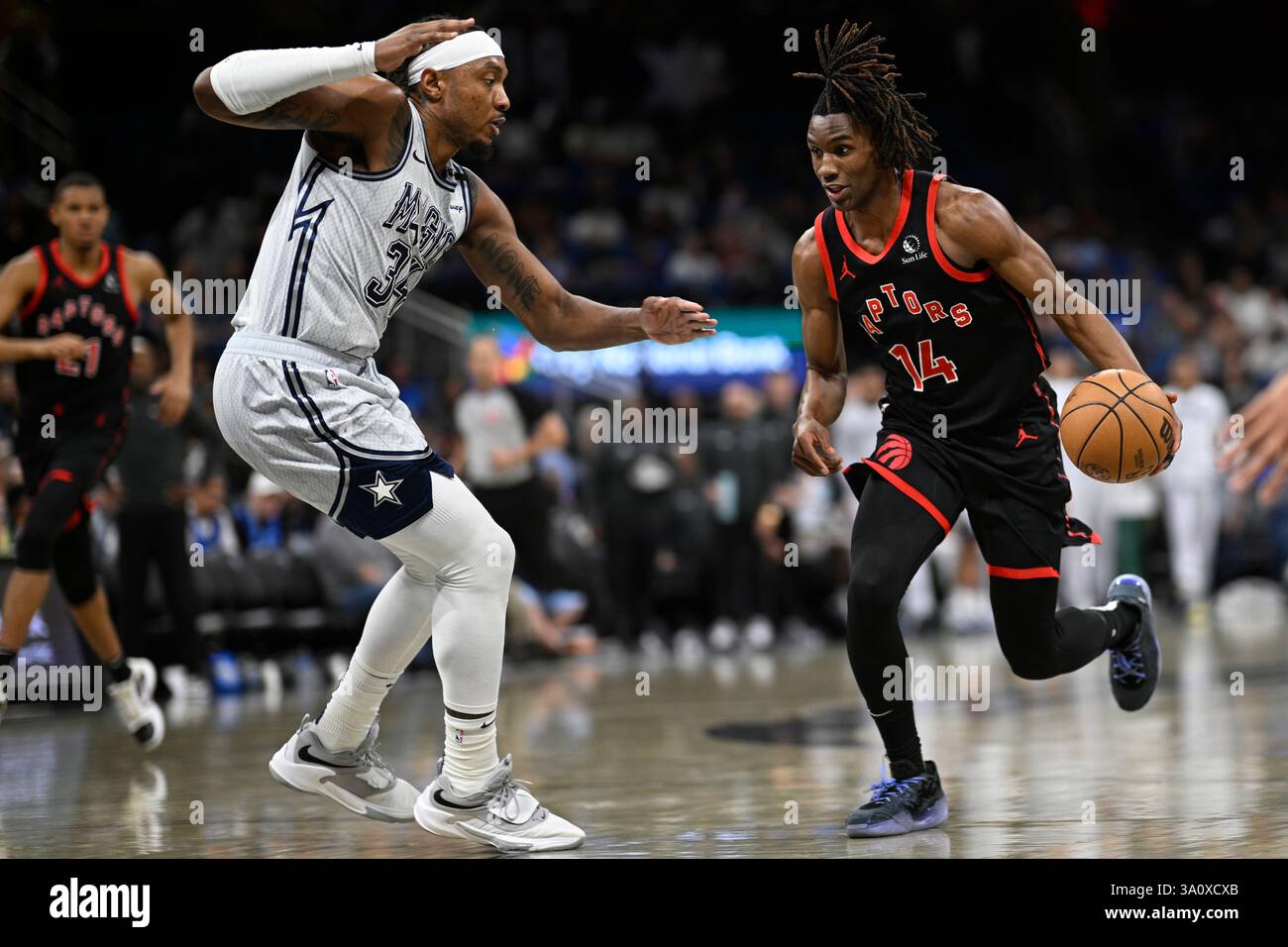 Toronto Raptors guard Ja'Kobe Walter (14) is defended by Orlando Magic ...