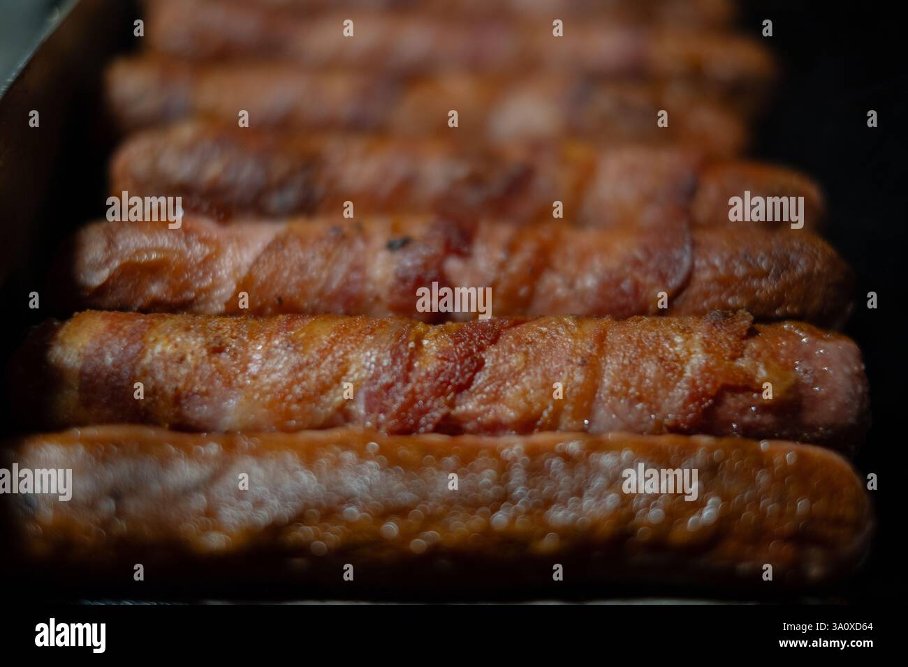 Frankfurter hot dog sausages fried with bacon Stock Photo - Alamy