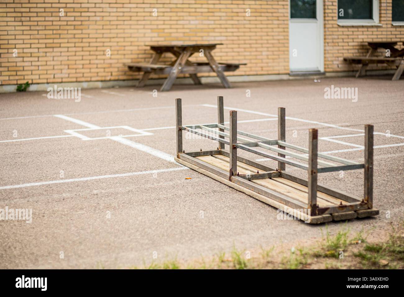 Upside down bench on schoolyard during summer break Stock Photo - Alamy
