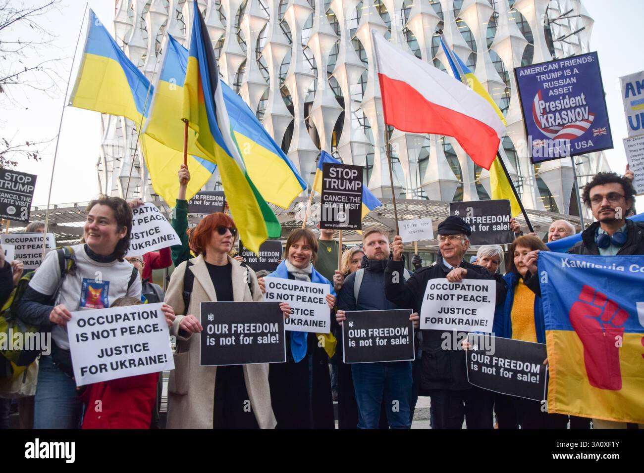 Protesters hold a Ukrainian flags and pro-Ukraine and pro-freedom ...