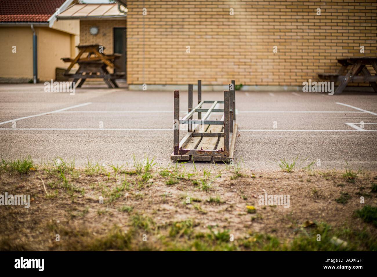 Upside down bench on schoolyard during summer break Stock Photo - Alamy