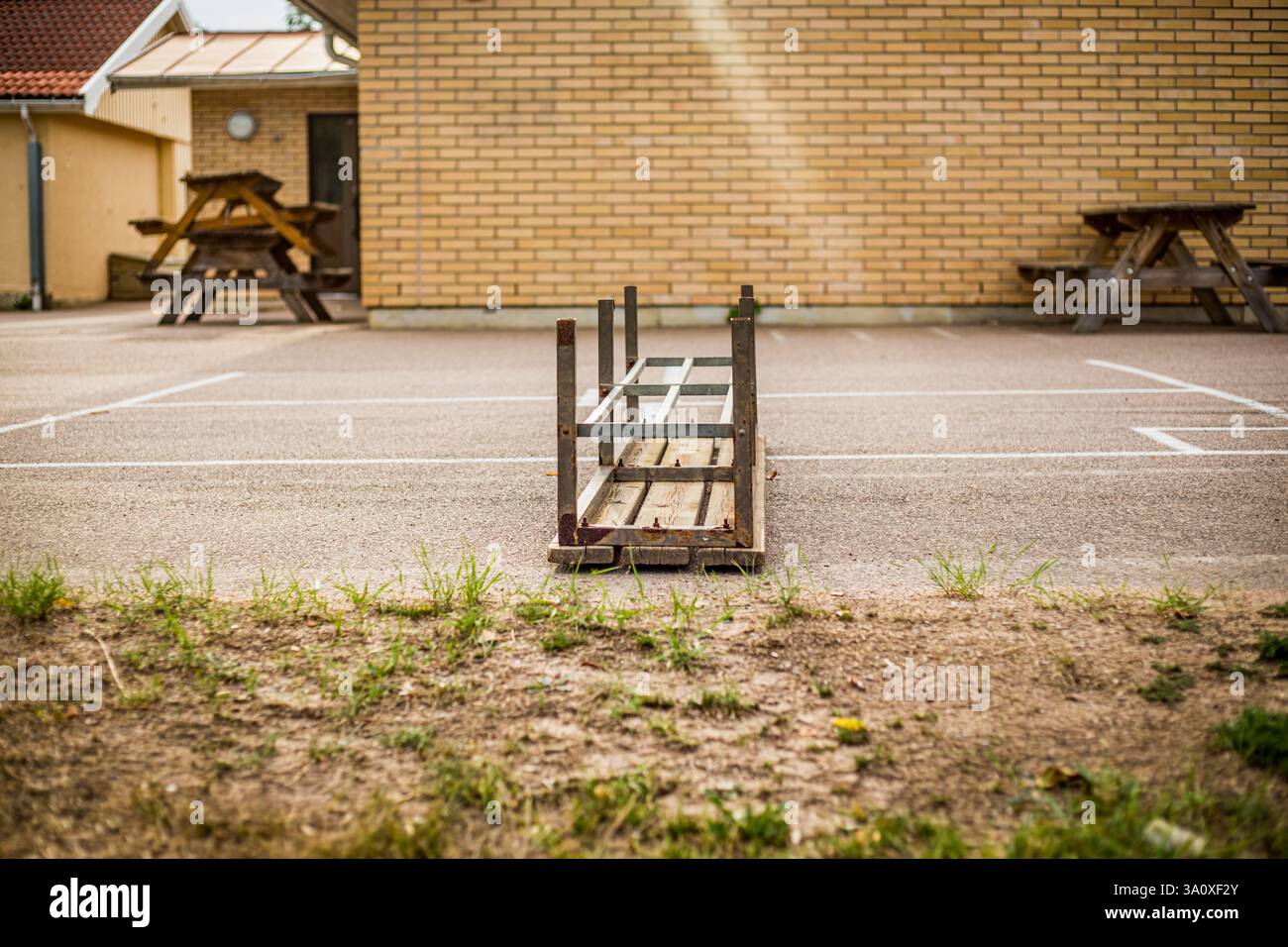 Upside down bench on schoolyard during summer break Stock Photo - Alamy