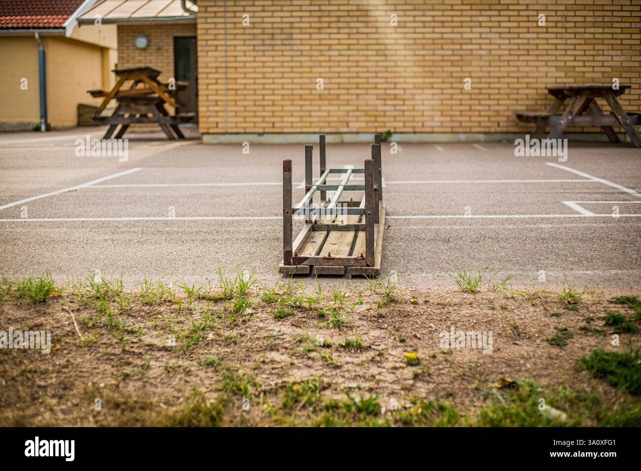 Upside down bench on schoolyard during summer break Stock Photo - Alamy