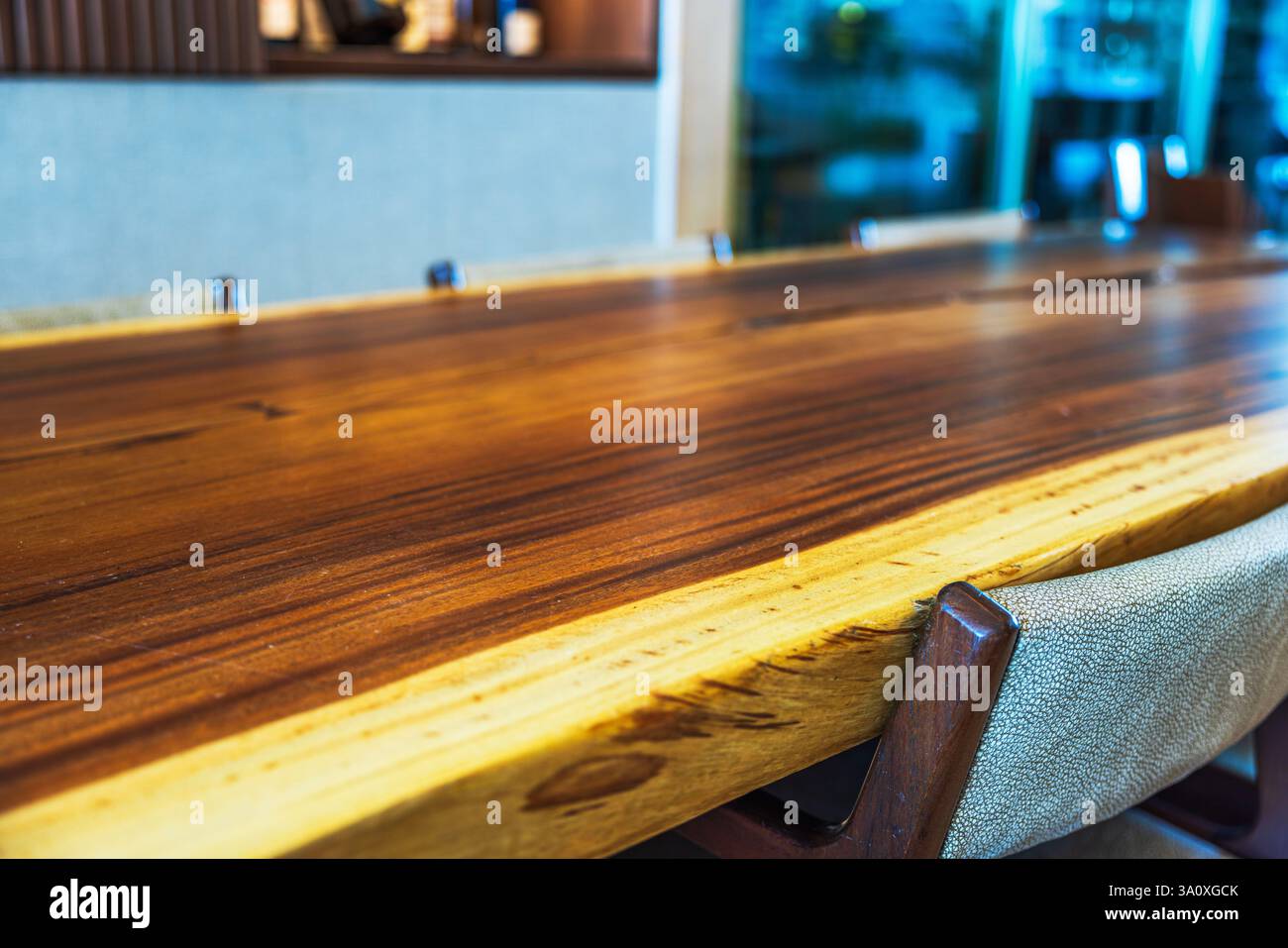 Polished wooden table with natural edges and chairs in hotel lobby ...