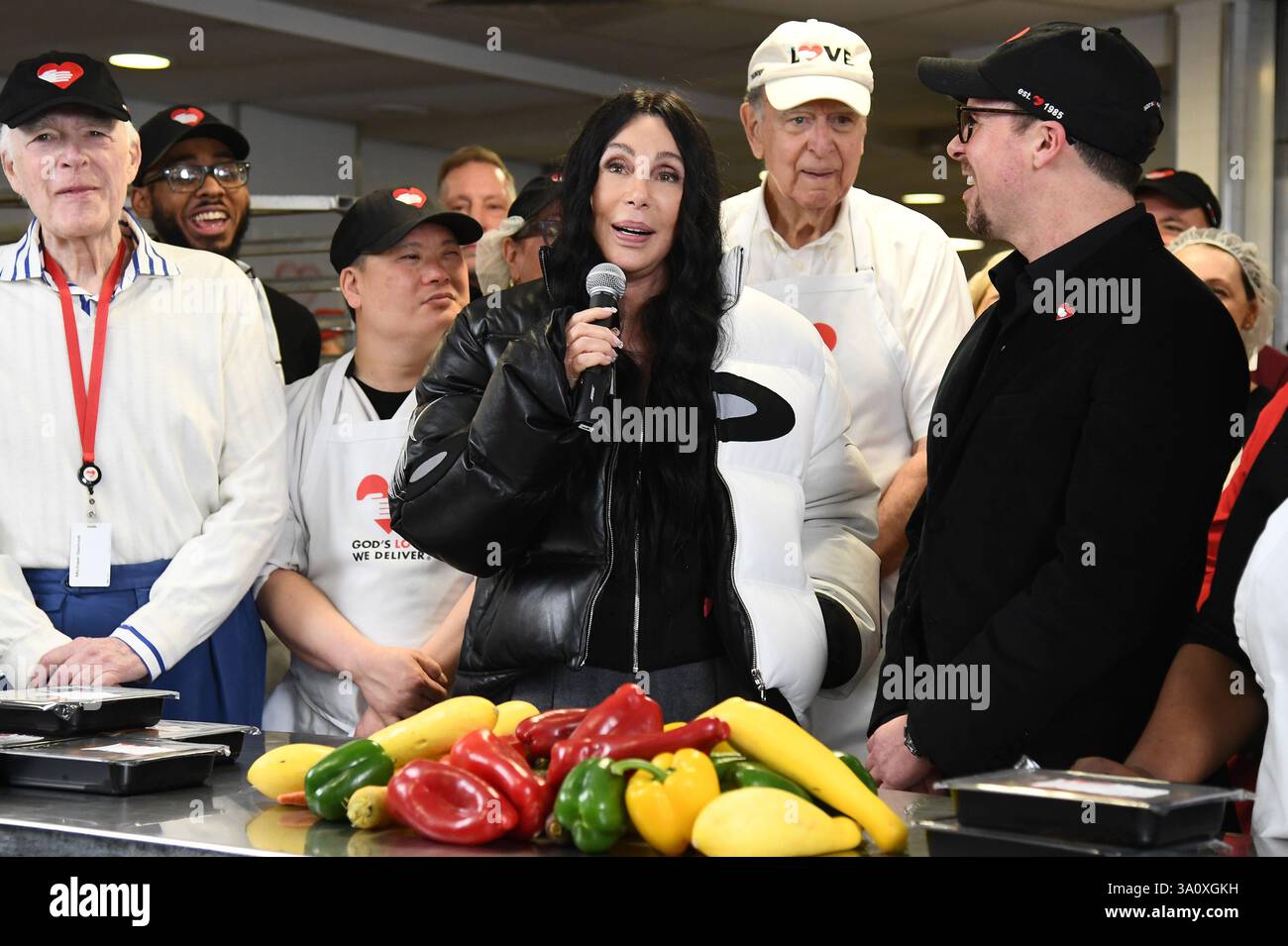 American singer Cher (center) visits with volunteers and kitchen staff ...