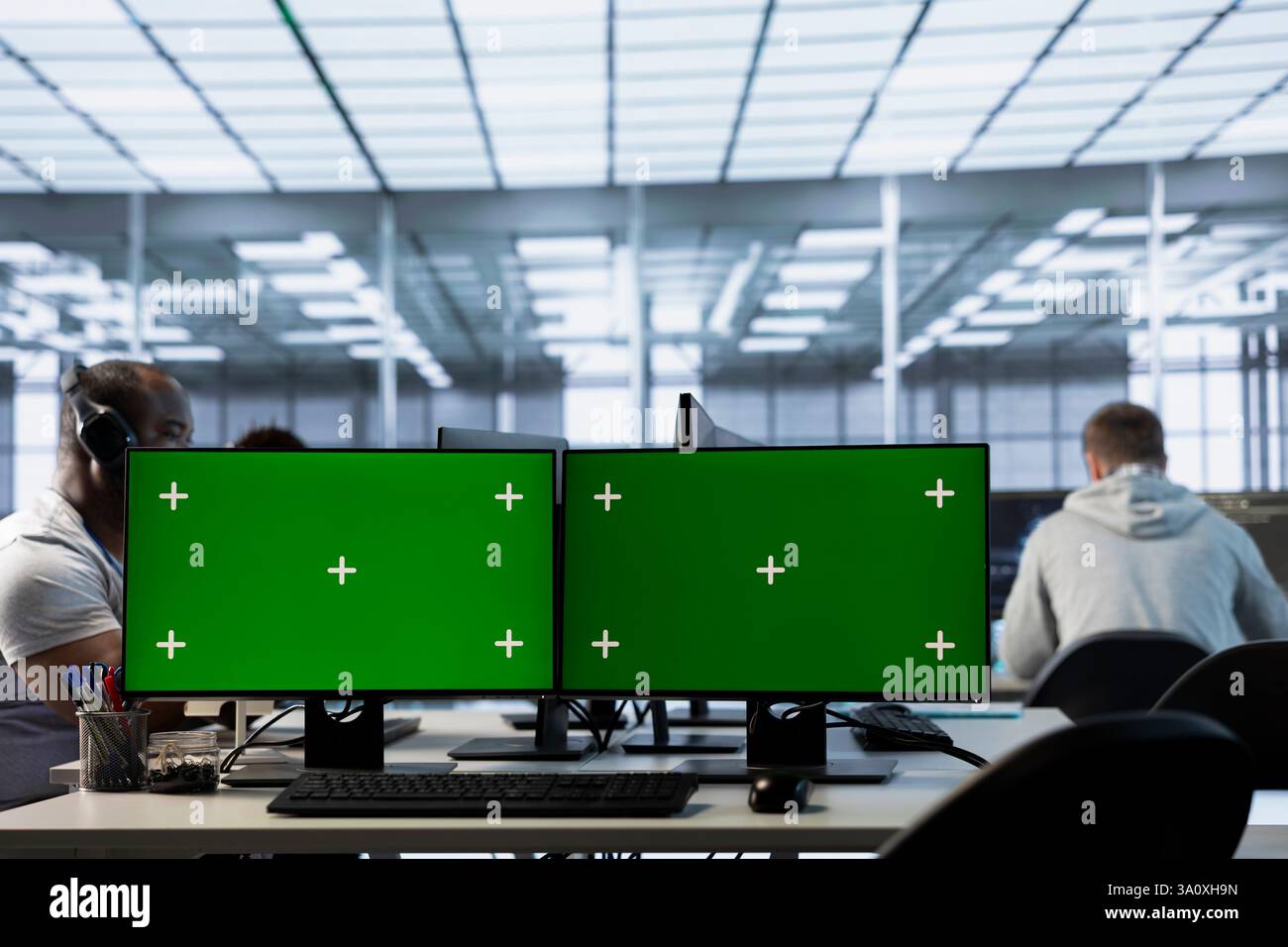 Technicians in data center using green screen PCs to coordinate deployment of server ...