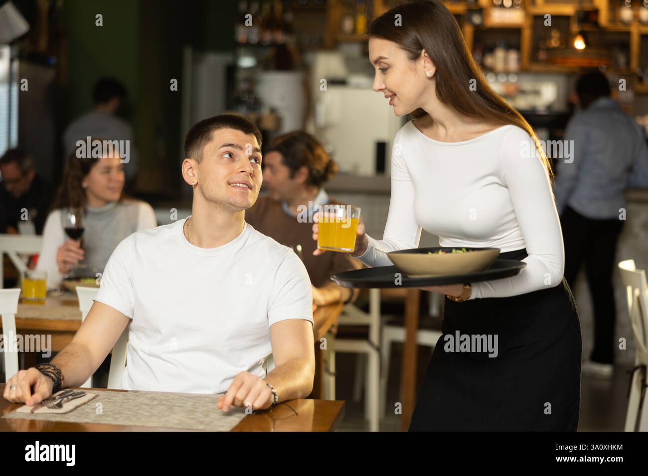 Guy makes an order in a restaurant with a female waitress Stock Photo ...