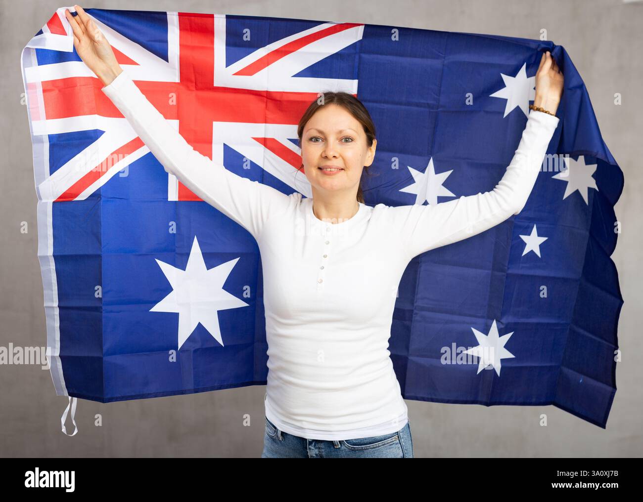 Happy woman posing with Australian flag in studio Stock Photo - Alamy