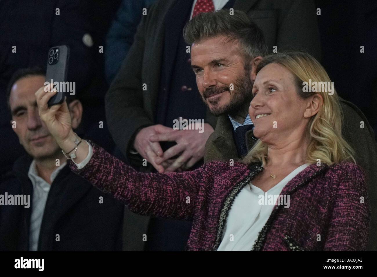 Former England soccer player David Beckham, center, poses for a photo ...