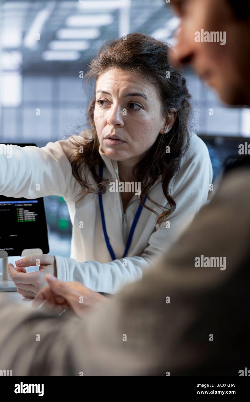 Teamworking colleagues in data center coordinating deployment of server architecture, improving ...