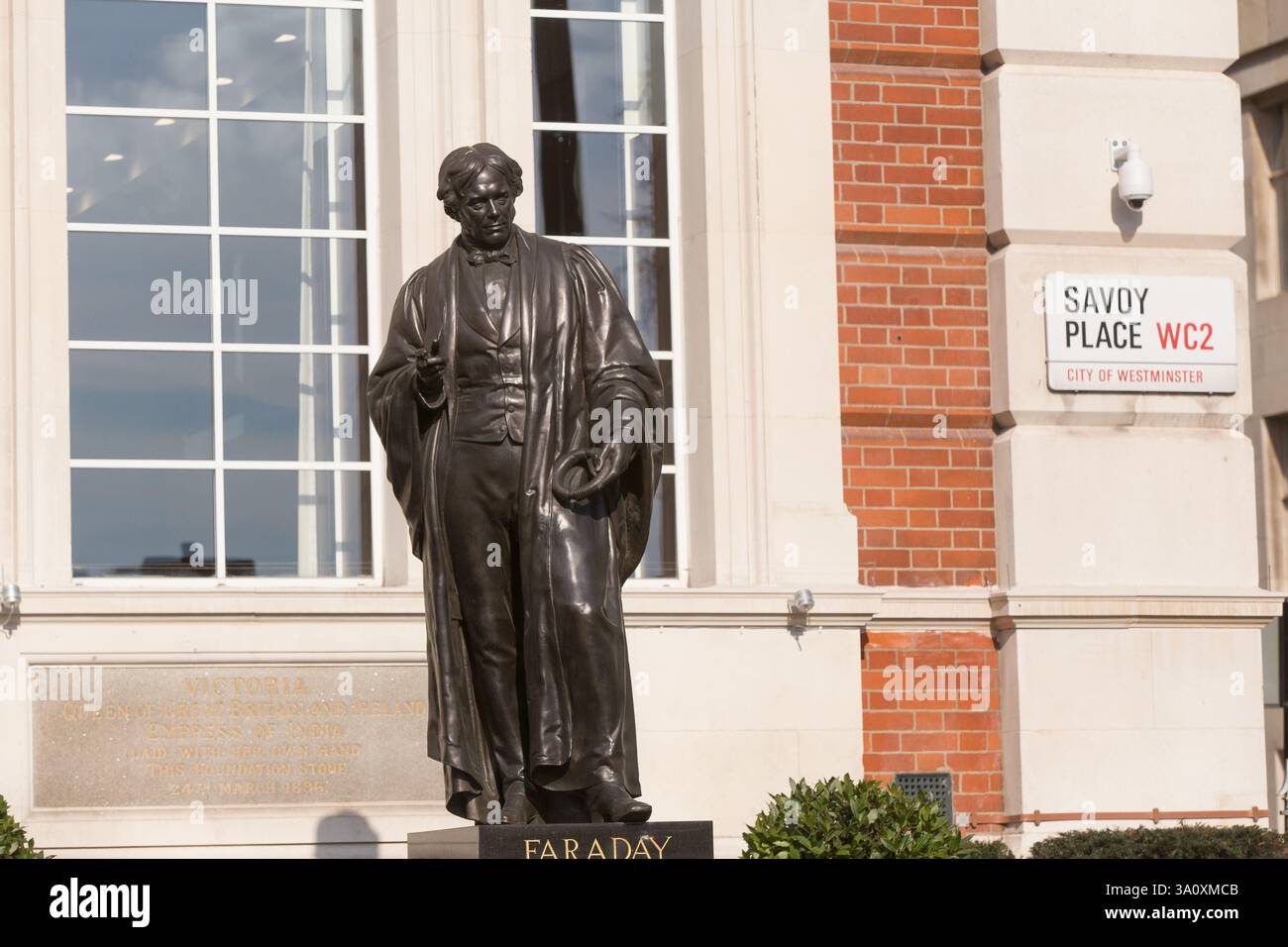 Statue of Michael Faraday at Savoy Place, London WC2. Queen Victoria ...